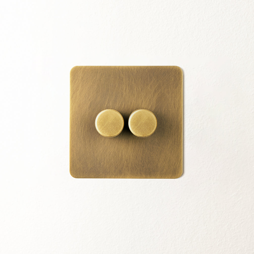Lucian two gang dimmer switch in aged brass