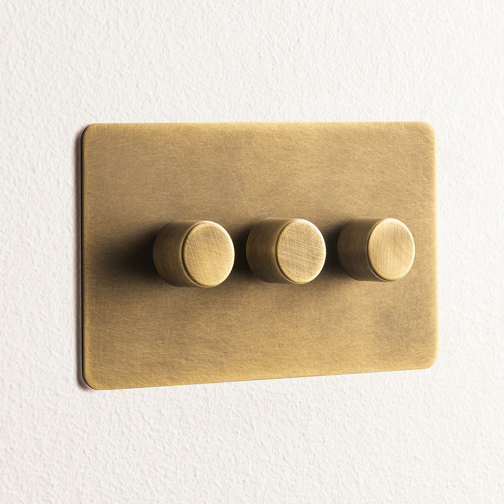 Lucian three gang dimmer switch in aged brass