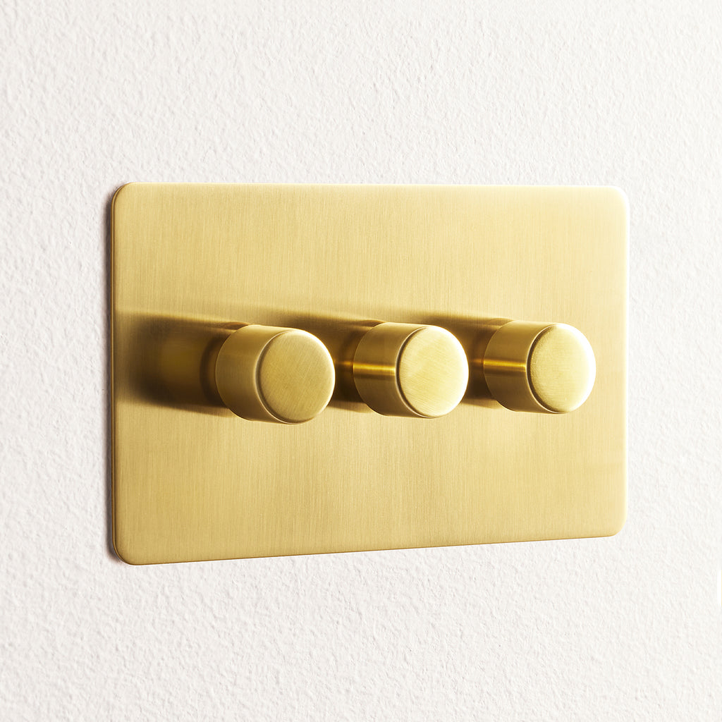Lucian three gang dimmer switch in top brass