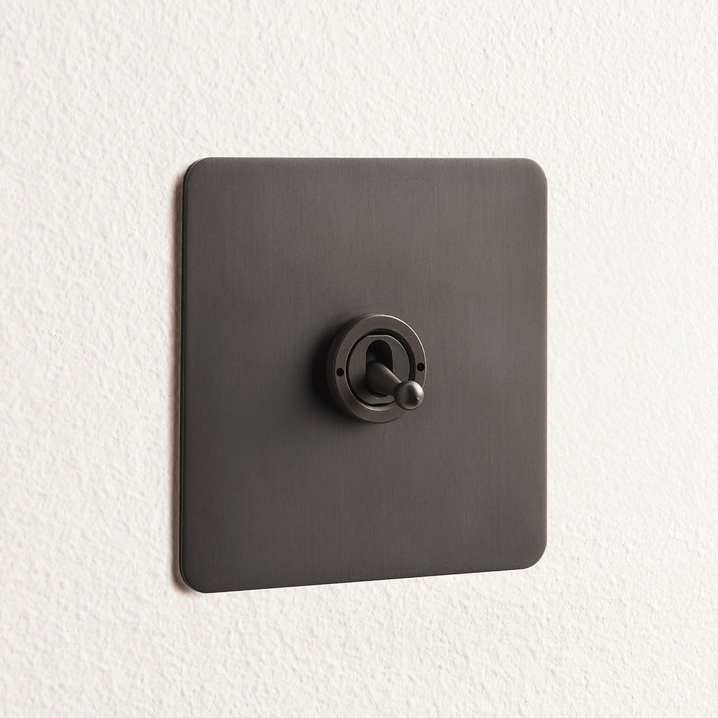 Lucian one gang intermediate toggle switch in bronze
