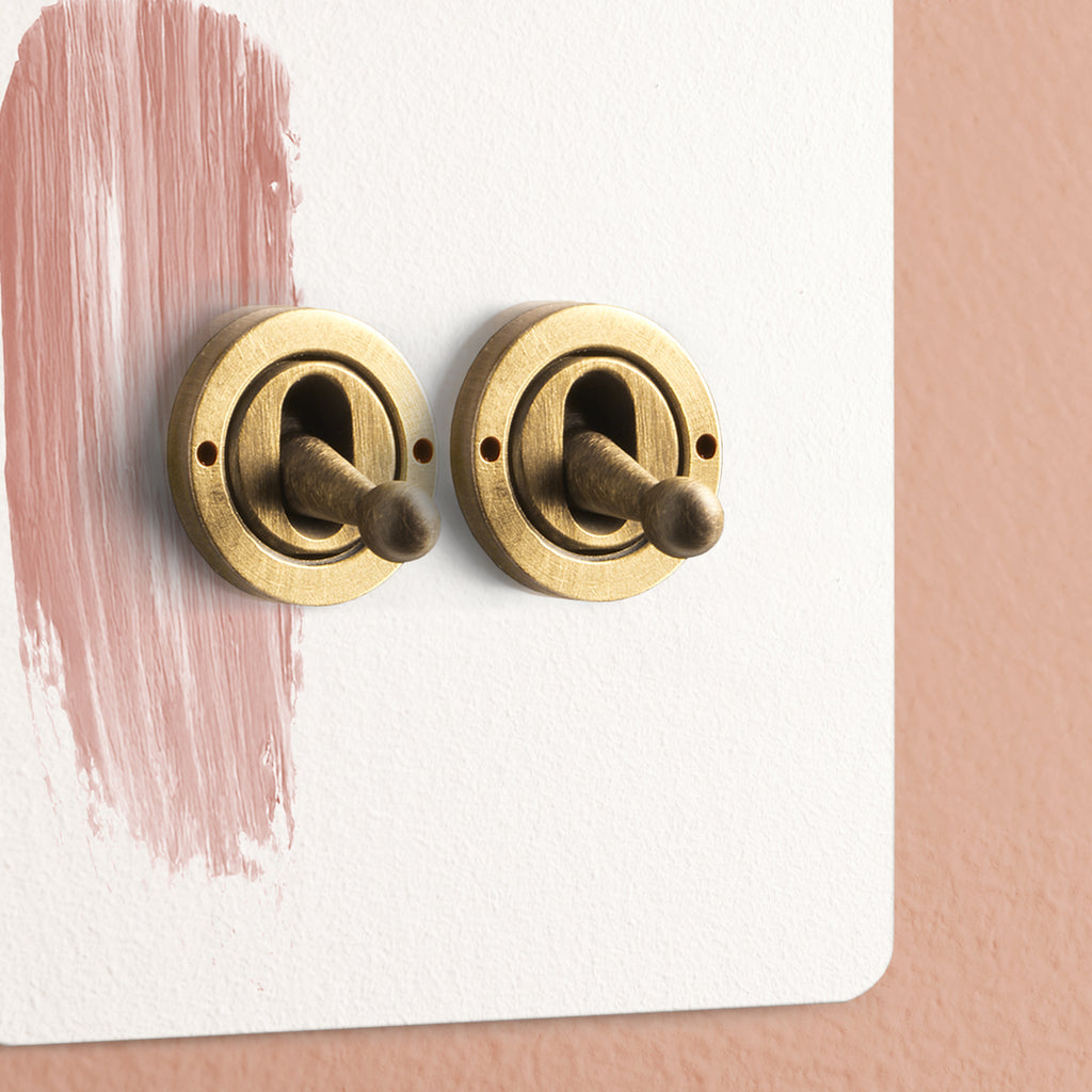 Lucian two gang intermediate toggle switch in a paintable finish