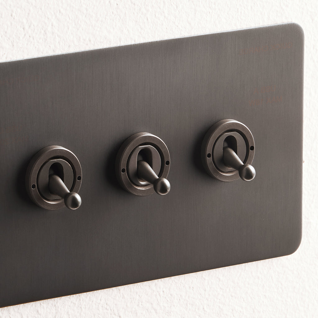 Lucian three gang 2 way toggle switch in bronze