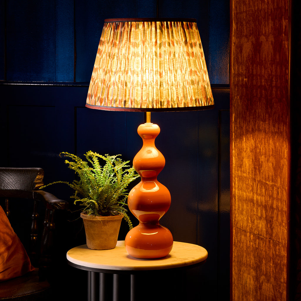 Smaller Wobster table lamp in burnt orange lacquered wood