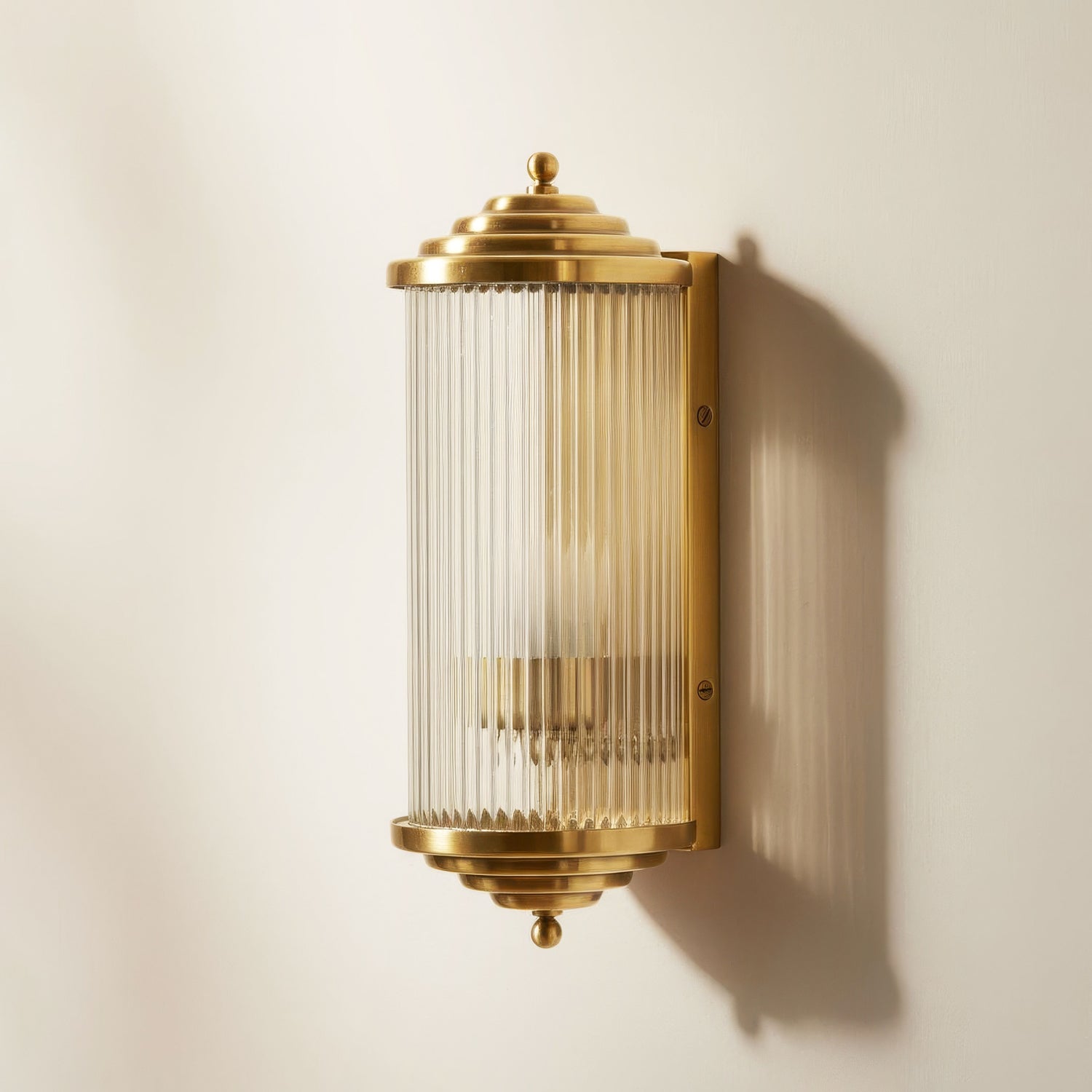 Deco Baby Roddy IP44 rated wall light in brass and glass