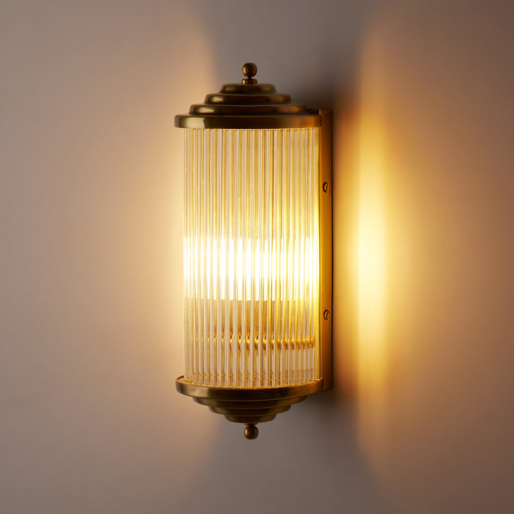 Deco Baby Roddy IP44 rated wall light in brass and glass