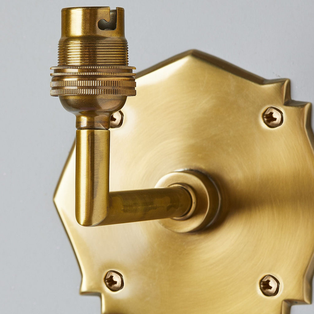 single insignia wall fitting in antique brass
